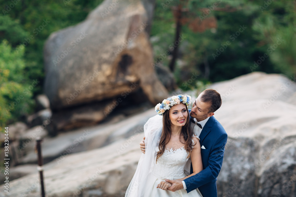 The lovely couple in love embracing and standing on the stones Stock ...