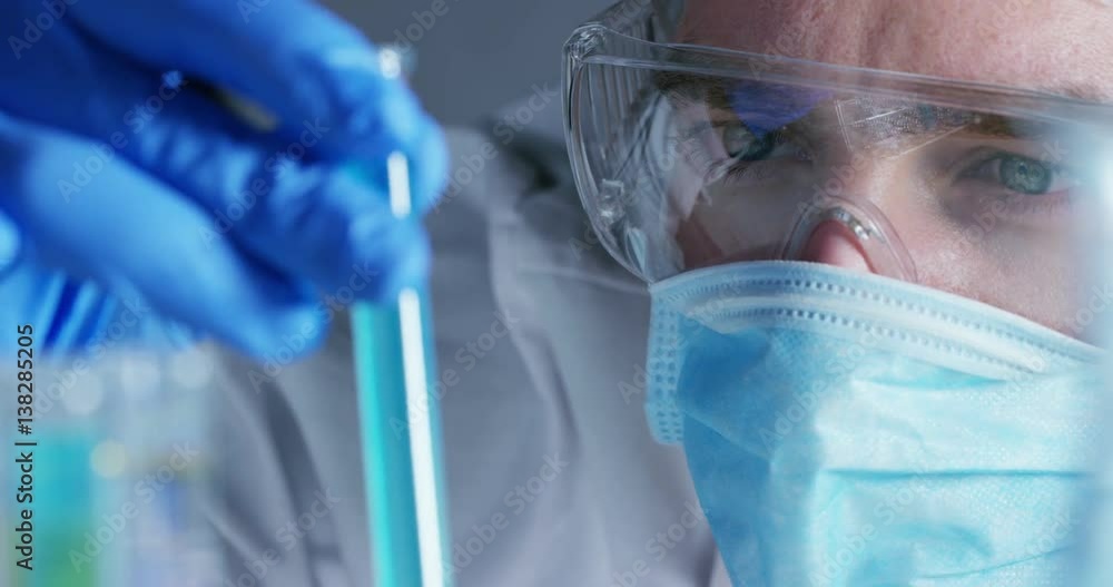 Close up of a scientist with futuristic graphics with which scans and ...