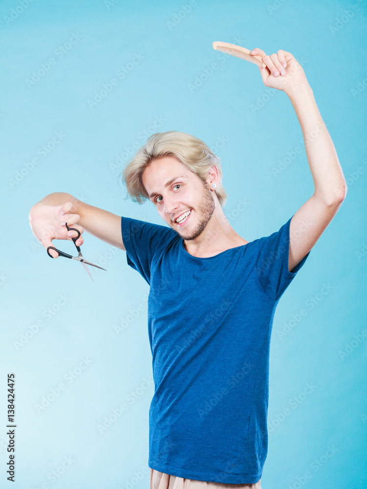 Man with scissors and comb creating new coiffure Stock Photo | Adobe Stock