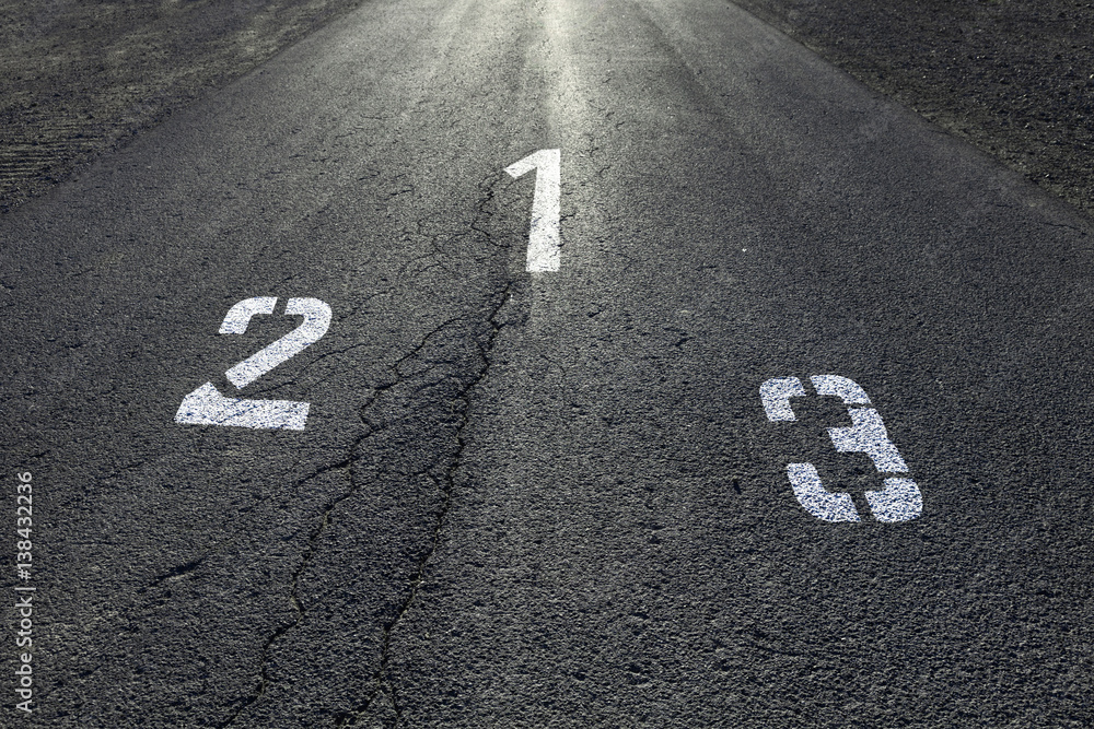 Foto de Sunny straight race asphalt road with painted first, second and ...