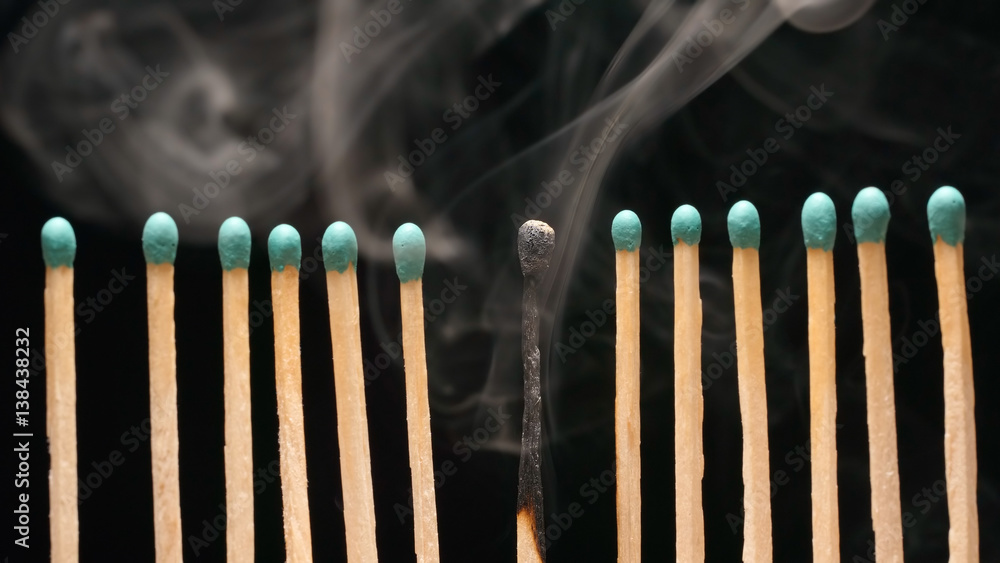 Smoke of single burned matchstick between row of new matchsticks Stock ...
