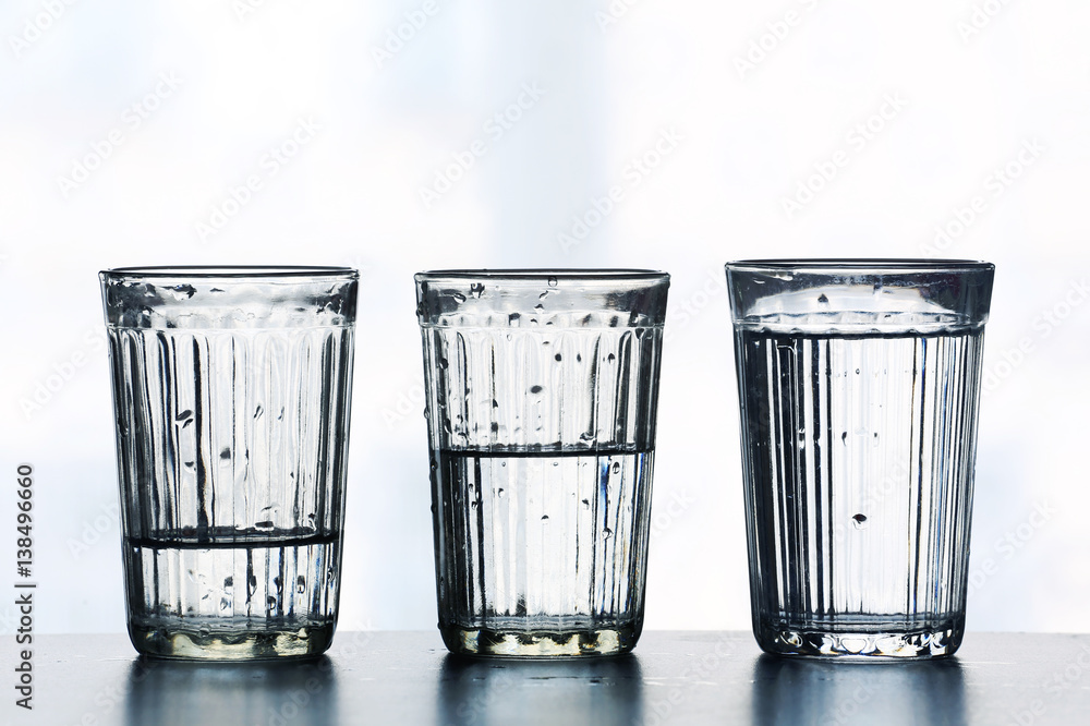 Three glasses with different levels of water Stock Photo | Adobe Stock