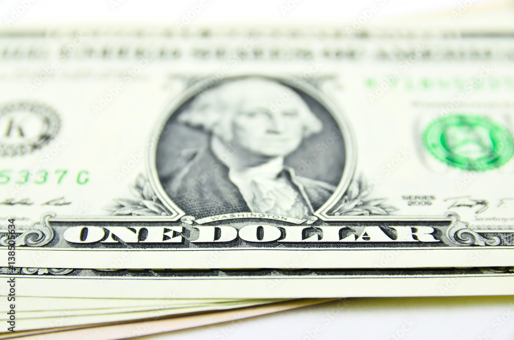 Foto Stock US dollars, one dollar sign in focus only | Adobe Stock