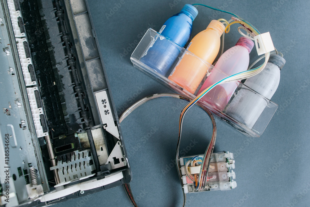 Ink-jet printer with ink tank system flat lay. Top view on gray office ...