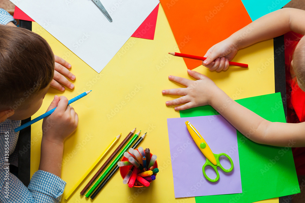 Little boy and girl doing crafts. Children ready to draw on colored ...