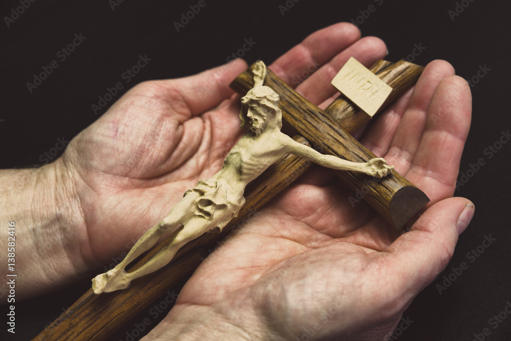 Jesus on cross in hands Stock Photo | Adobe Stock