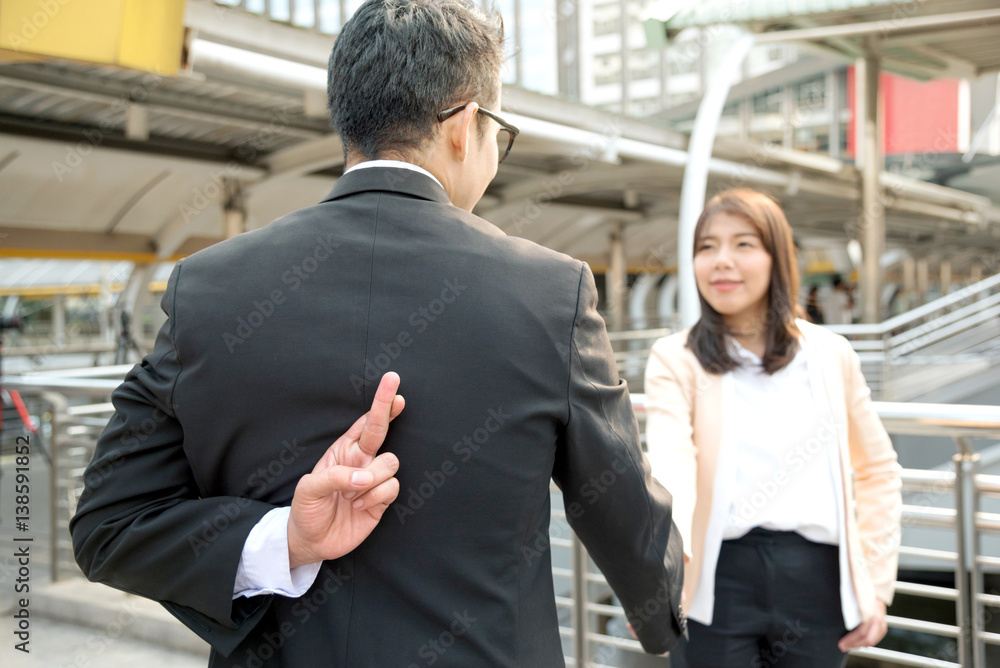 Two business people shaking hand making a deal but Business man holding ...