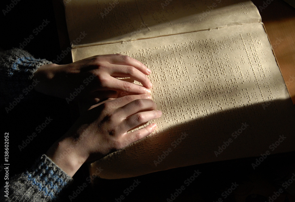 blind reading text in braille. close-up of human hands reading braille ...