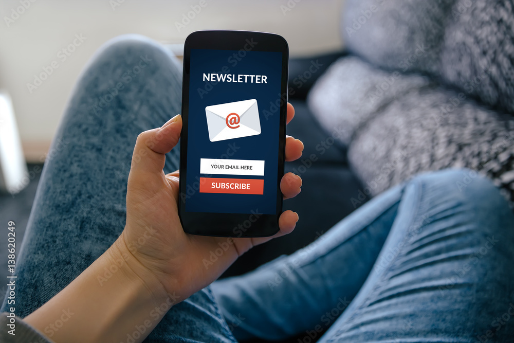 Girl holding smart phone with subscribe newsletter concept on screen ...