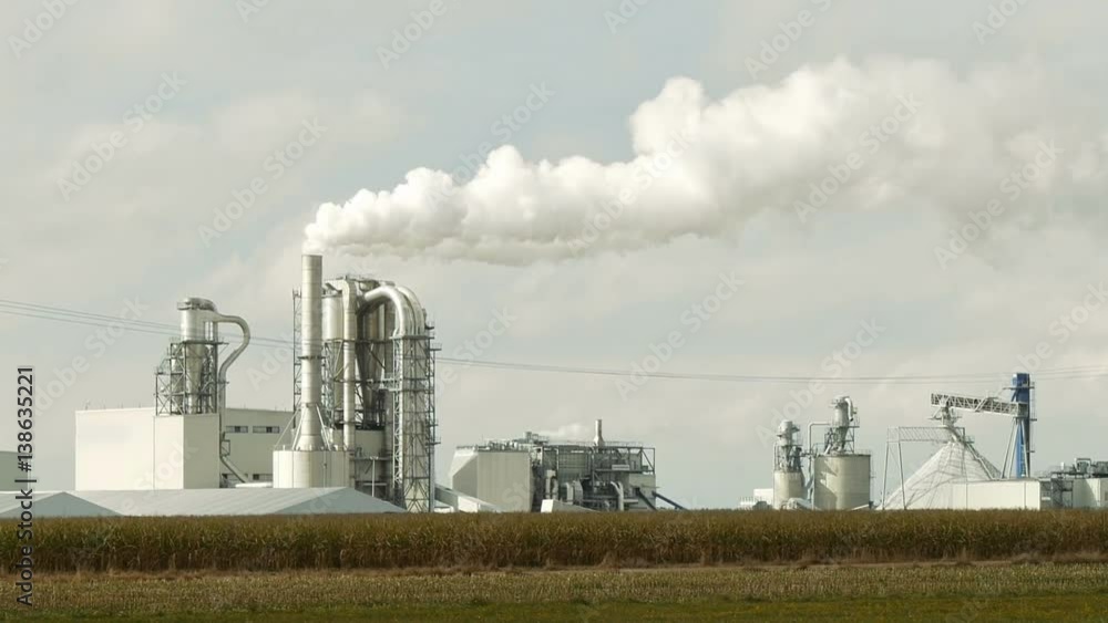 Factory smoke stack and pipes puff into air. Atmospheric air pollution ...