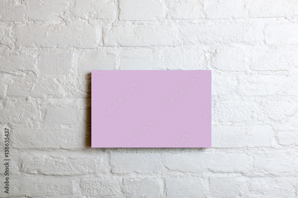 Pink blank poster in a white brick wall. Template Mock up for your ...