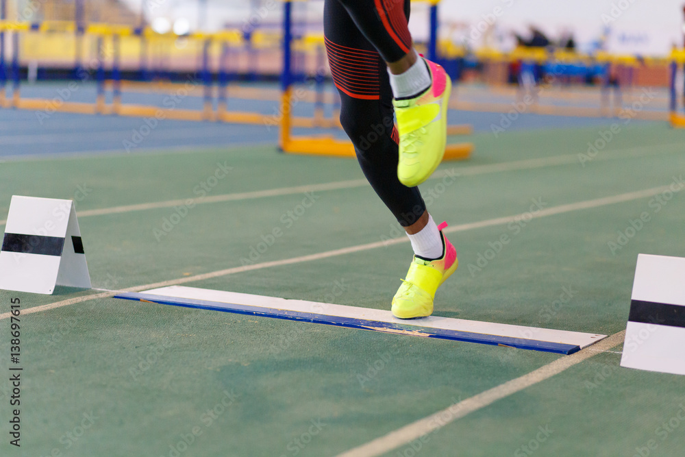 Sportsman landing his leg on board before taking off in long jump or ...