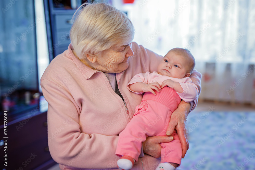 Great grandmother holding newborn baby grandchild on arm Stock Photo ...