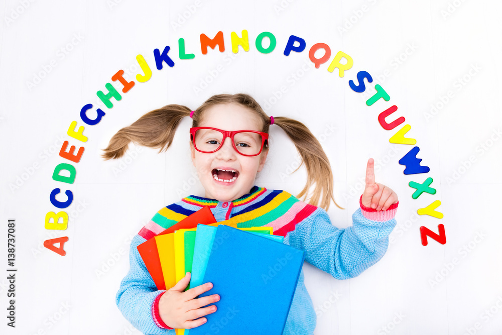 Child learning letters of alphabet and reading Stock Photo | Adobe Stock