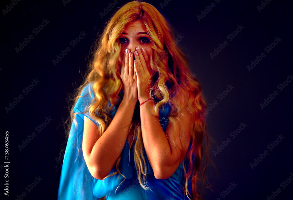Frightened woman screaming with fear indoor at halloween night. Horror ...