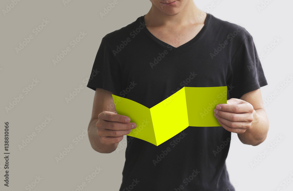 Man reading blank yellow flyer brochure booklet. Leaflet presentation ...