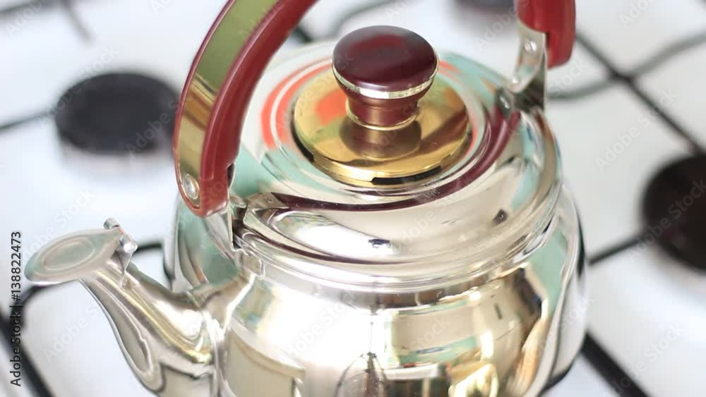 Steaming teapot on a gas-fire Stock Video | Adobe Stock