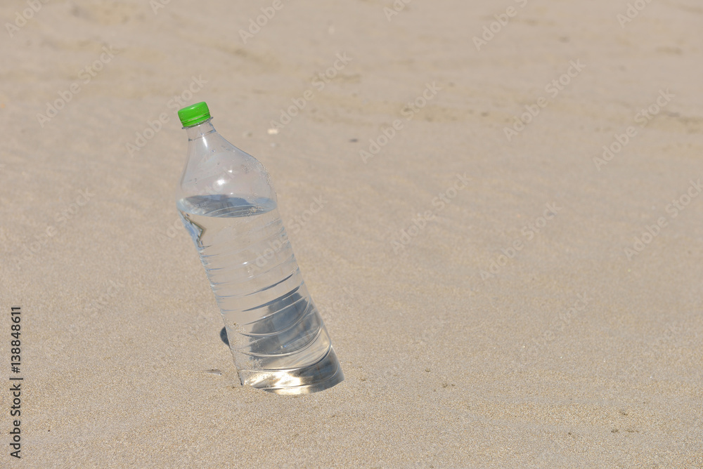 Ice cold unlabelled bottle of refreshing water standing upright in the ...