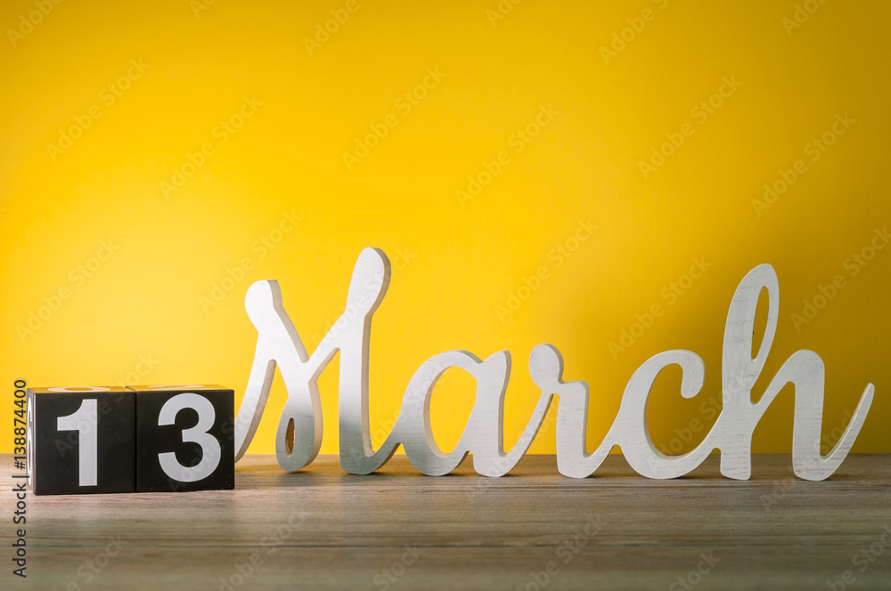 March 13th. Day 13 of month, daily wooden calendar on table with yellow ...