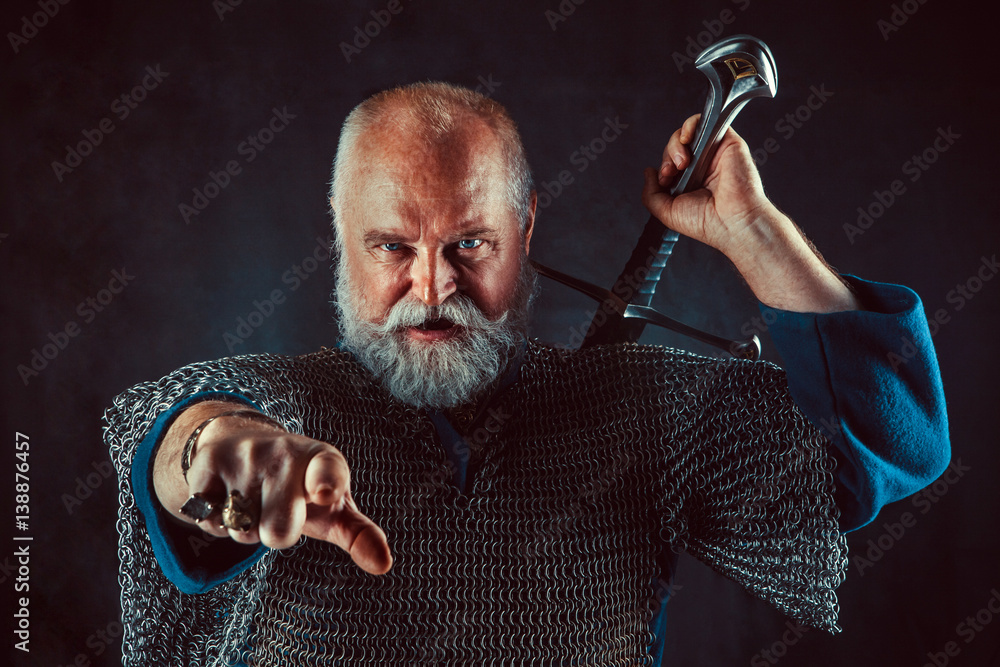 Powerful bearded knight with the sword on the dark background Photos ...