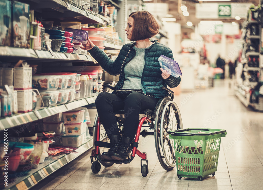 Disabled woman in a wheelchair in a department store Stock Photo ...