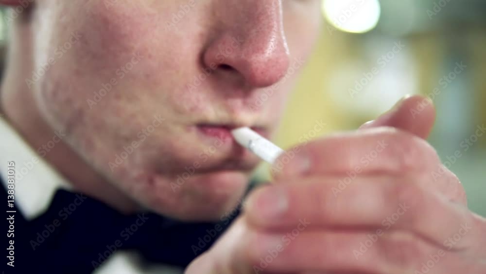 Close up view of a cigarette being lightened Toxic inhaling. Young ...