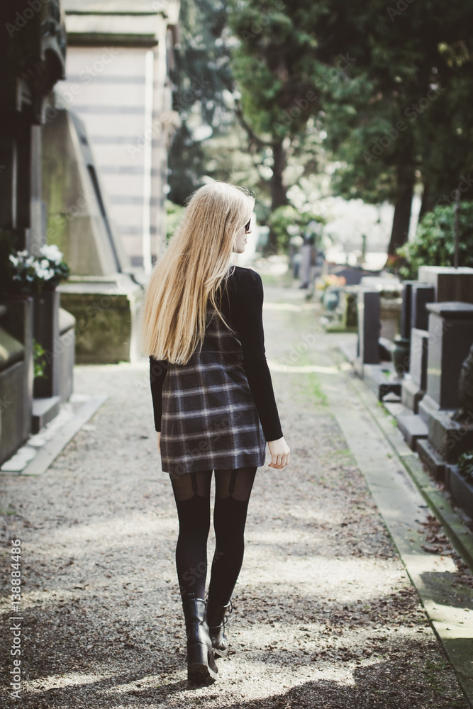 Blond girl alone at cemetery, Cimitero Monumentale, Milan, Italy Stock ...