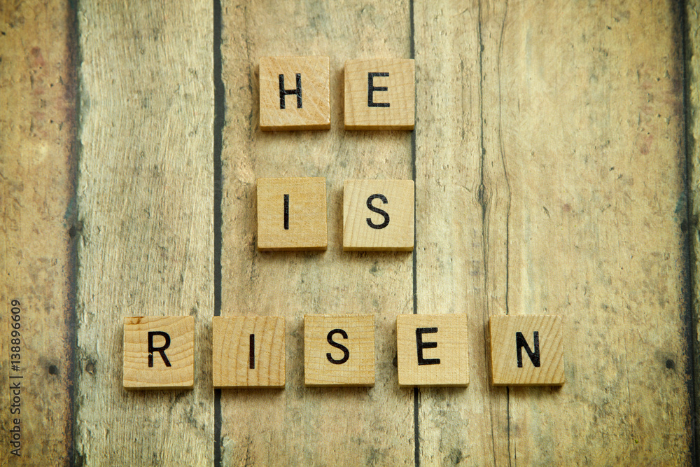 He is Risen Christian blocks on a wood plank background Stock Photo ...