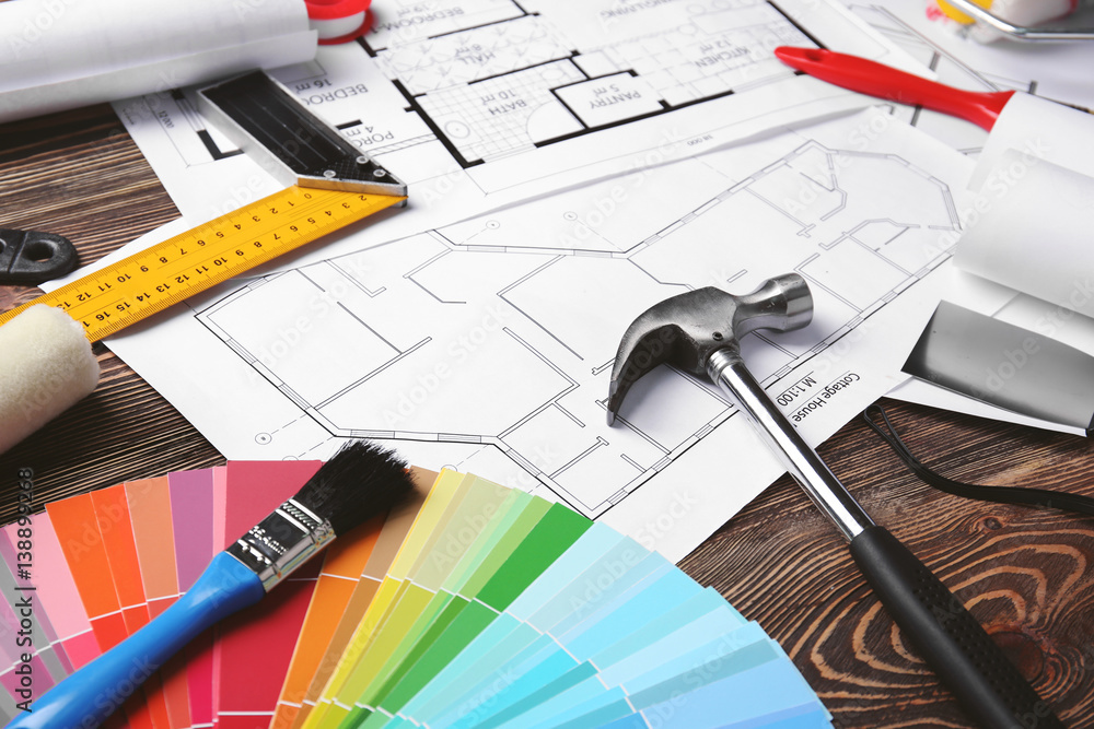 Decorator workplace with house project, color swatches and tools ...