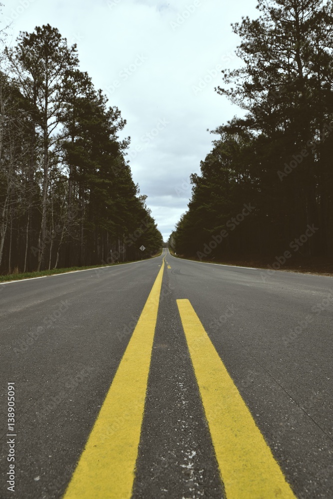 Looking down center highway road yellow stripes Stock Photo | Adobe Stock