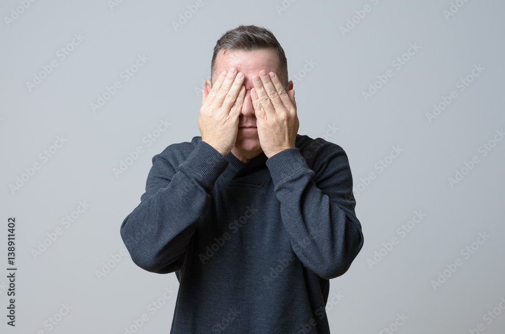 Man covering his face Stock Photo | Adobe Stock