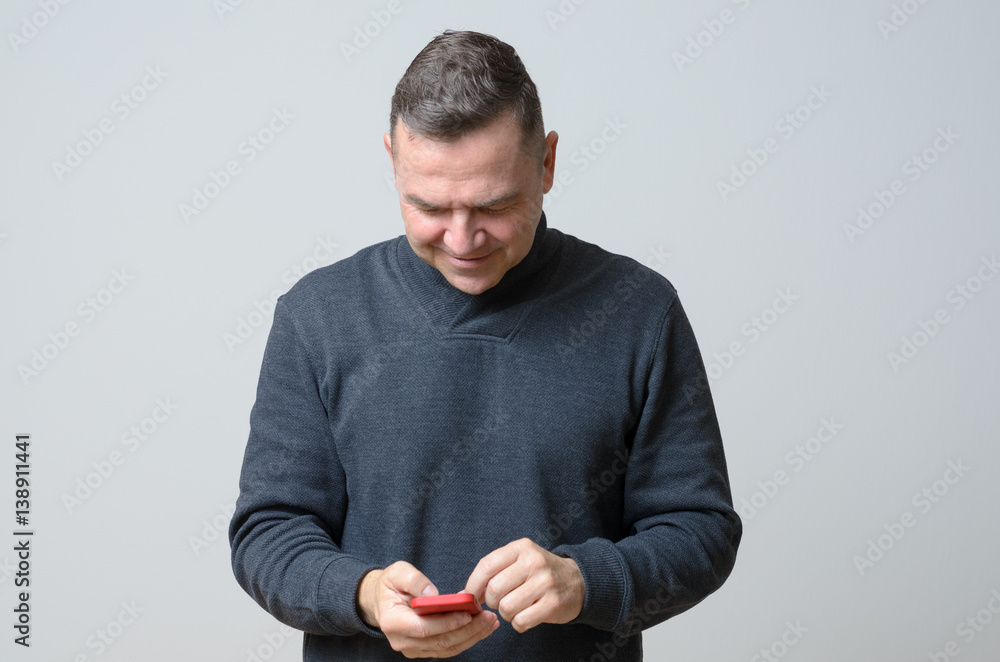 Man looking at cellphone Stock Photo | Adobe Stock