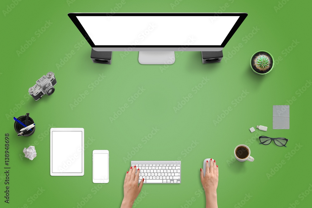 Top view of studio desk with modern devices. Computer display, tablet ...