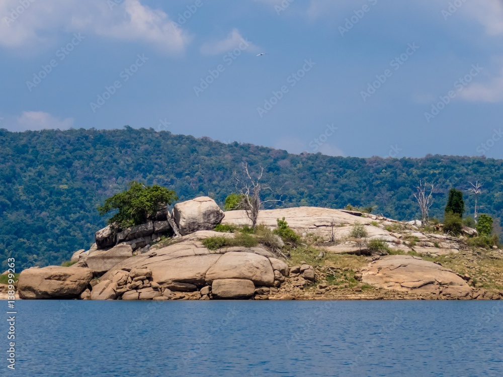 Rock formed island with trees in Inginiyagala Senanayake Samudraya lake ...