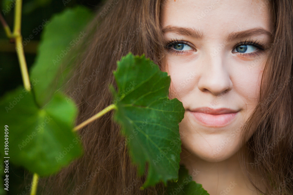 Cleseup portrait of beautiful woman face in green leaves, young fresh ...