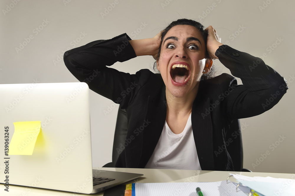 busy attractive woman in business suit working in stress screaming ...