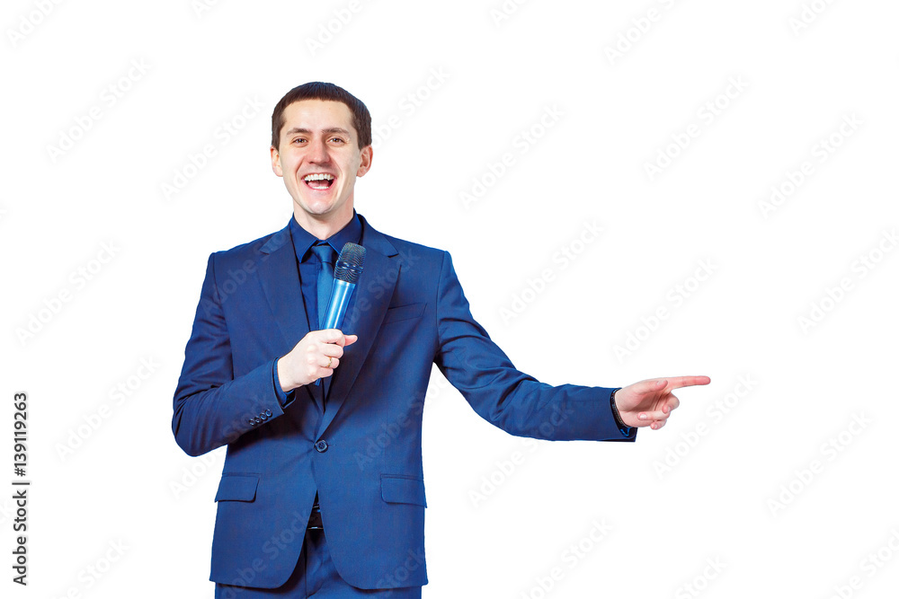 Elegant young man with microphone is laughing and pointing isolated at ...