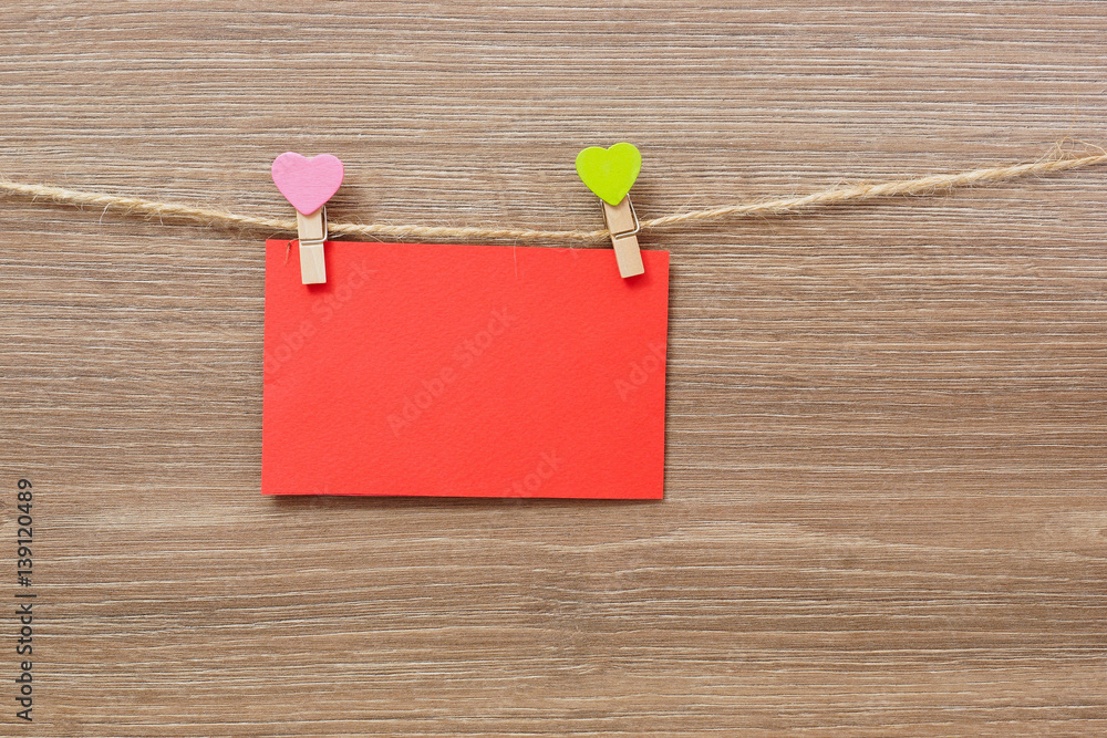 Red greeting card hanging on a clothesline. Wooden background Stock ...