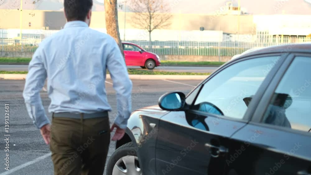 One angry man goes out of his stopped car and then opens the car hood ...