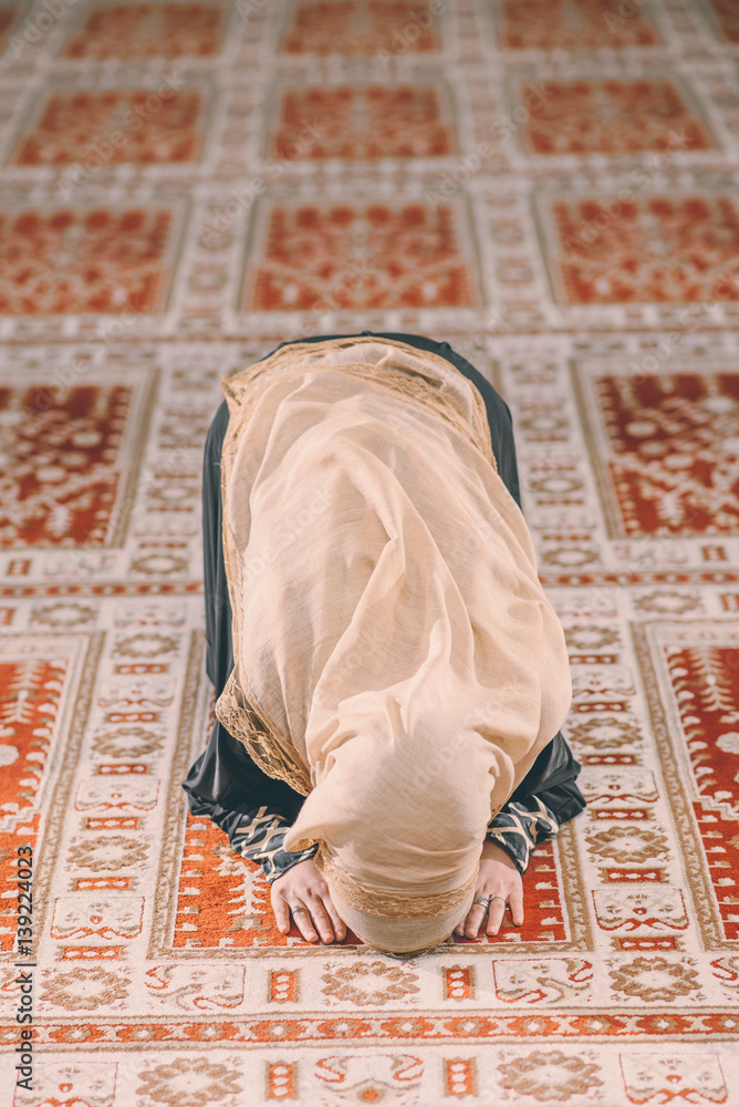 Muslim woman prostration while praying Stock Photo | Adobe Stock