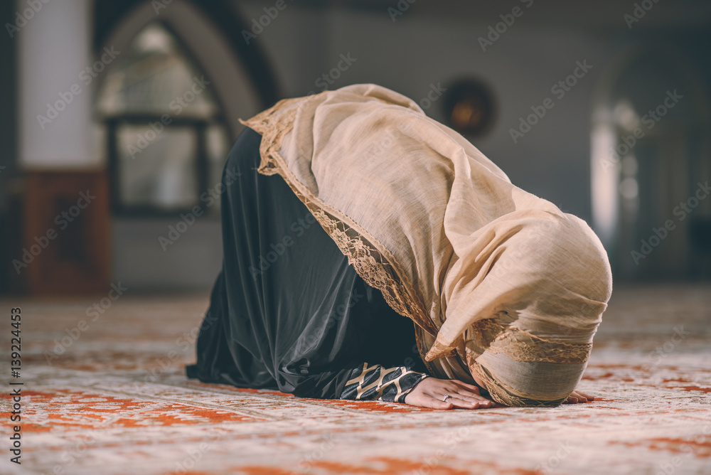 Muslim woman prostration while praying Stock Photo | Adobe Stock