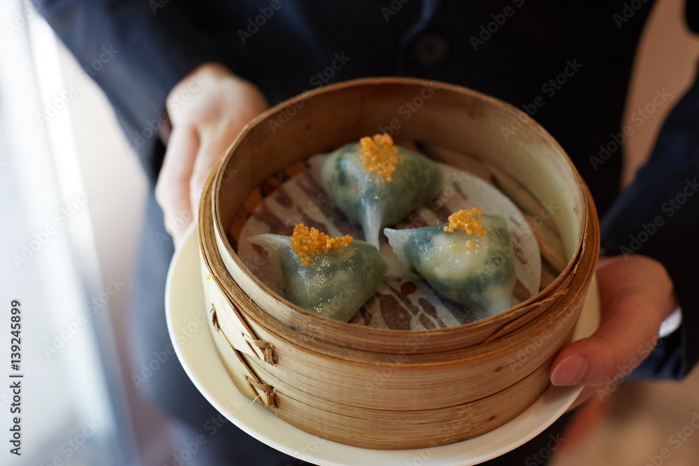 Traditional Chinese dumplings in bamboo steamer Stock Photo | Adobe Stock