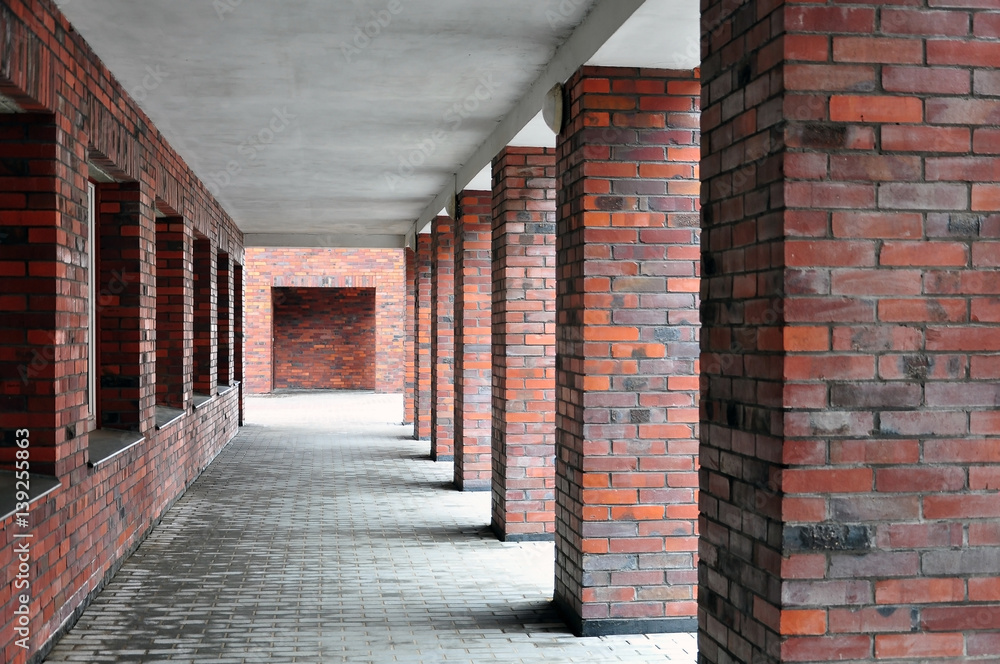 Architectural composition, exterior. Many red brick square columns and ...