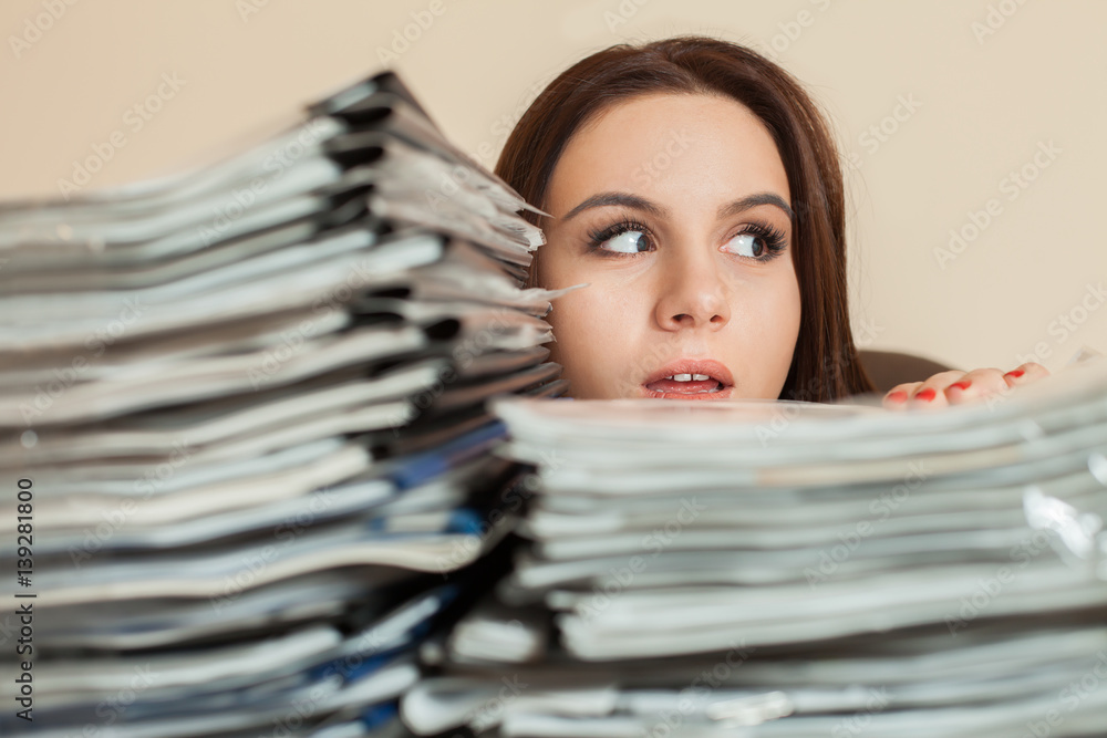 Female bookkeeper with large stacks of documents Stock Photo | Adobe Stock