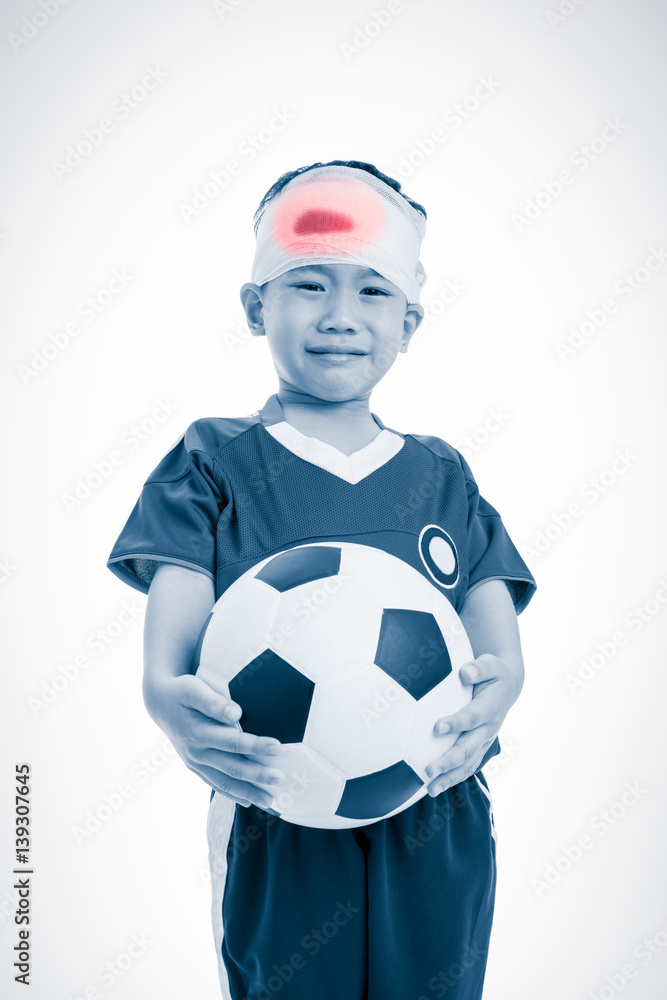 Sports injury. Sad asian boy with trauma of the head holding a football ...