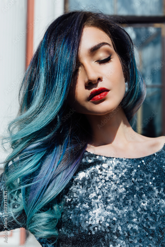 Fashion portrait of gorgeous girl with blue dyed hair long. The ...
