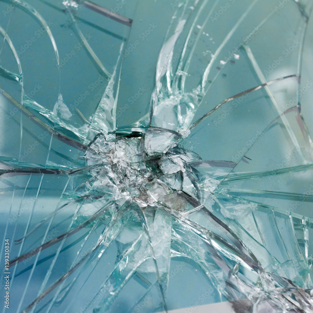 Firearms bullethole on the glass from the bullets, cracks background ...