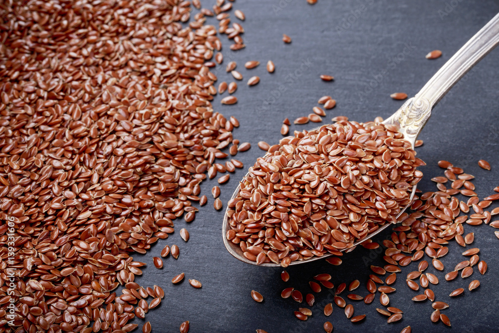 flax seeds on black background Stock Photo | Adobe Stock
