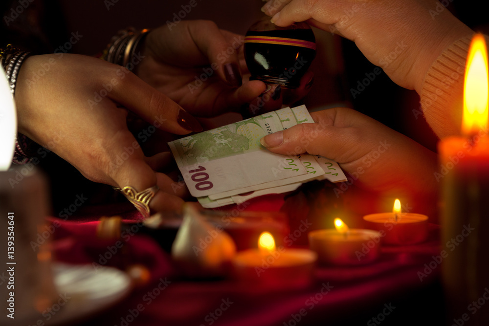 Gypsy woman taking a money from her customer for magic potion Stock ...