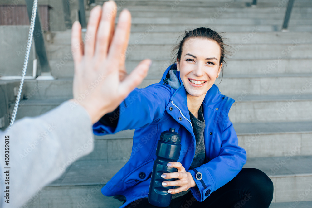 First person view of a man and woman high fiving. Happy young woman in ...